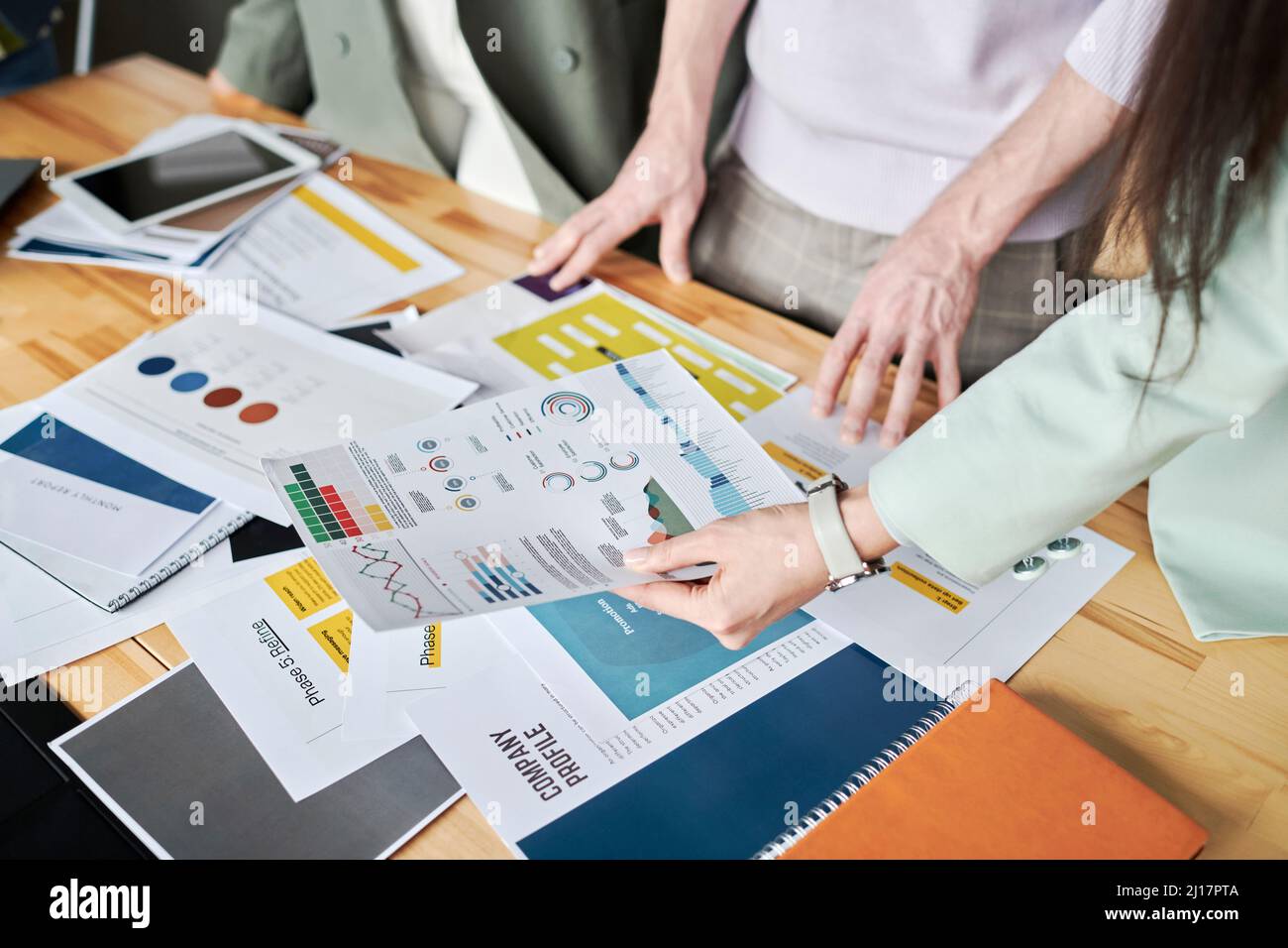 Office colleagues reviewing infographics on desk at office Stock Photo ...