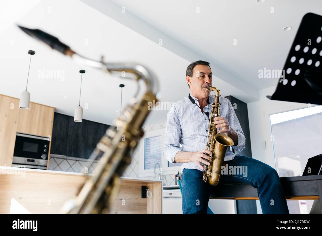 Playing saxophone at home hi-res stock photography and images - Alamy