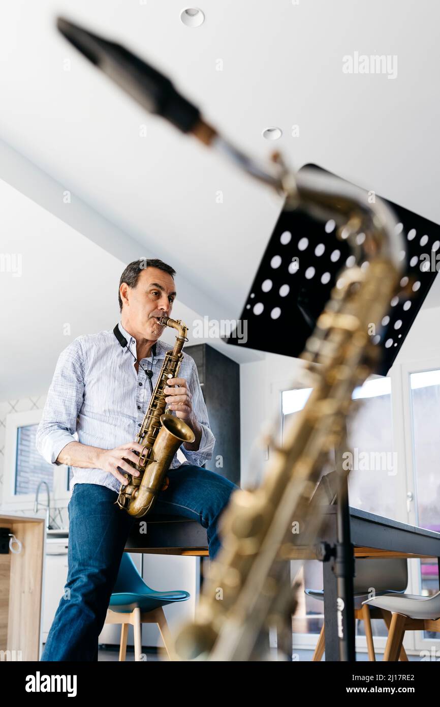 Playing saxophone at home hi-res stock photography and images - Alamy