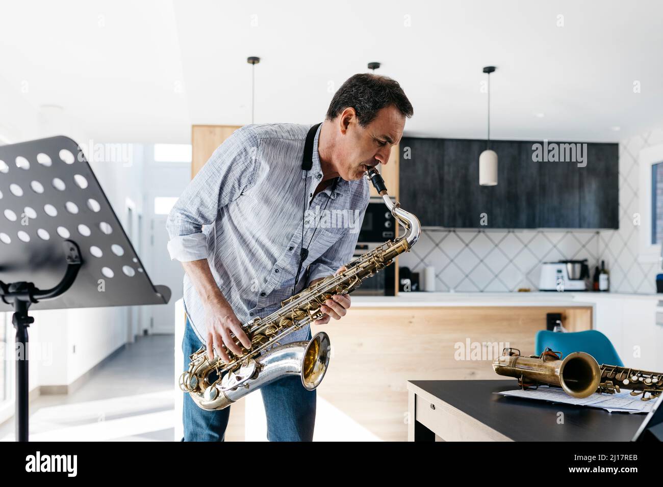 Playing saxophone at home hi-res stock photography and images - Alamy