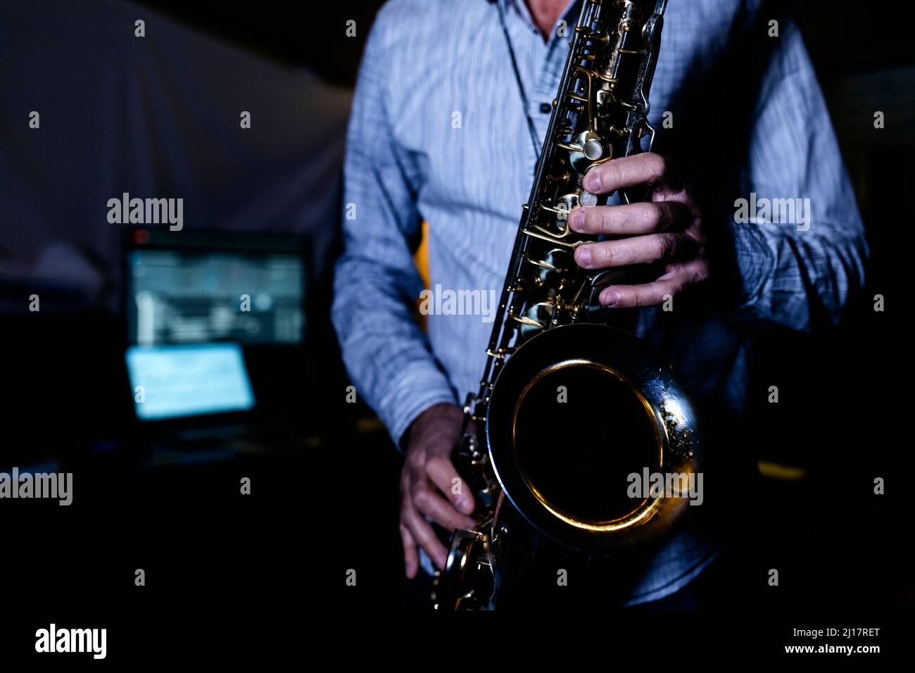 Saxophonist playing saxophone in recording studio Stock Photo - Alamy