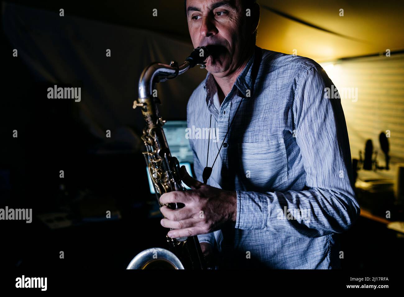Musician playing saxophone practicing in recording studio Stock Photo ...