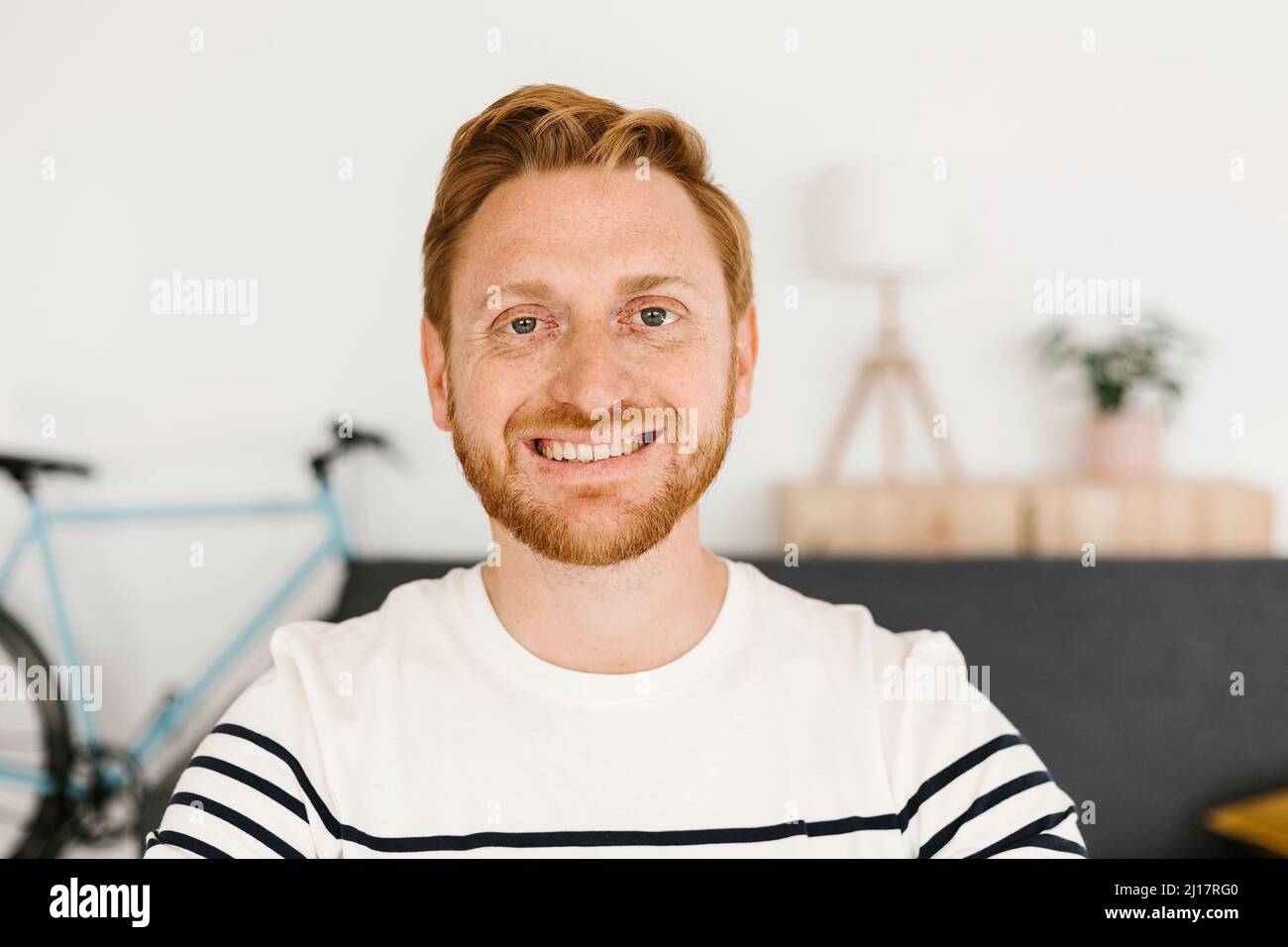 Happy young man with red hair at home Stock Photo - Alamy
