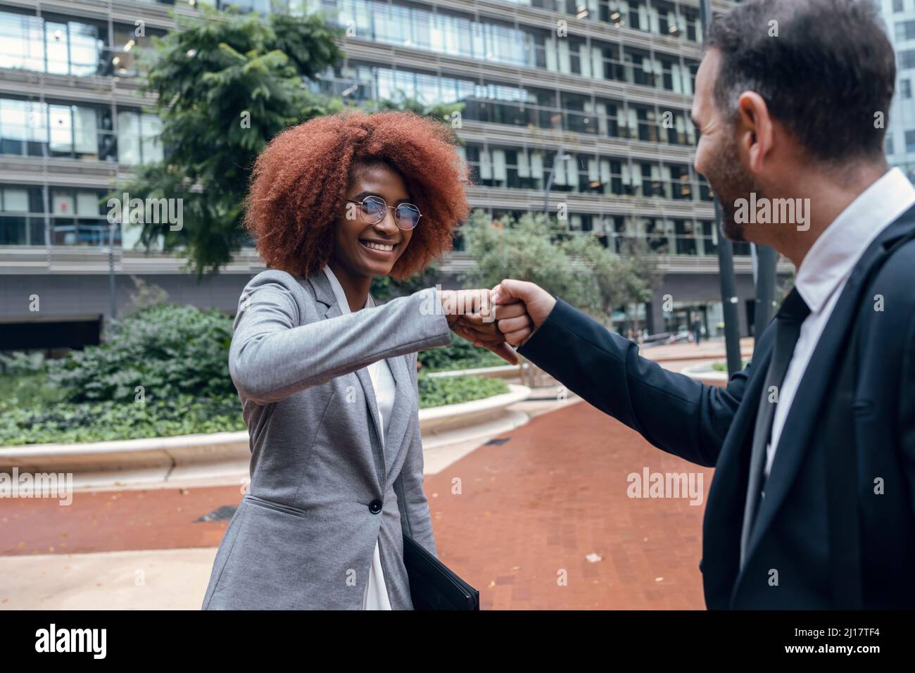 Two business colleagues fist bumping outdoors Stock Photo - Alamy