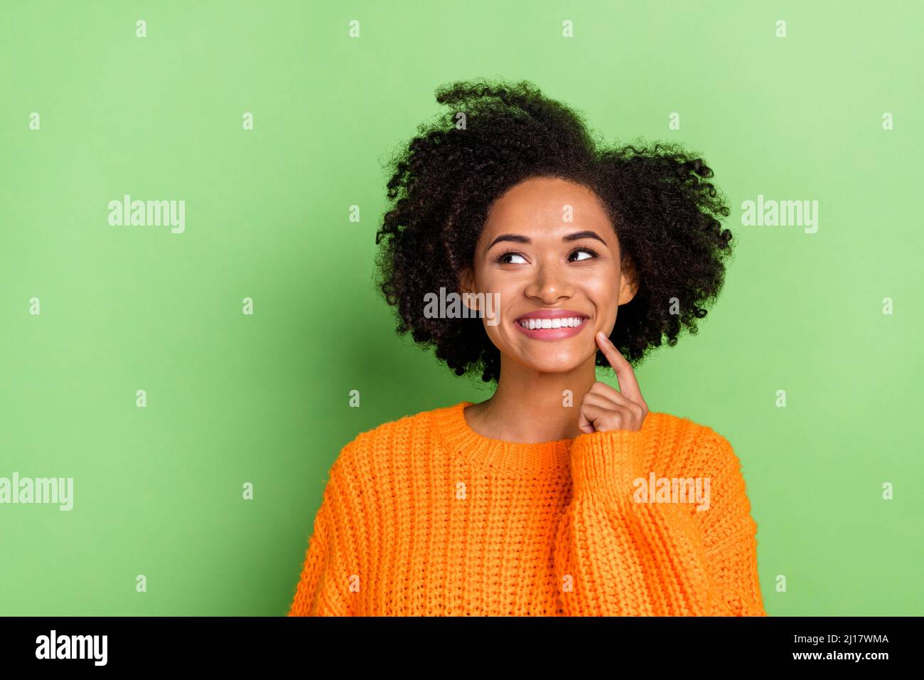 Photo of sweet young curly hairdo lady look empty space wear orange ...