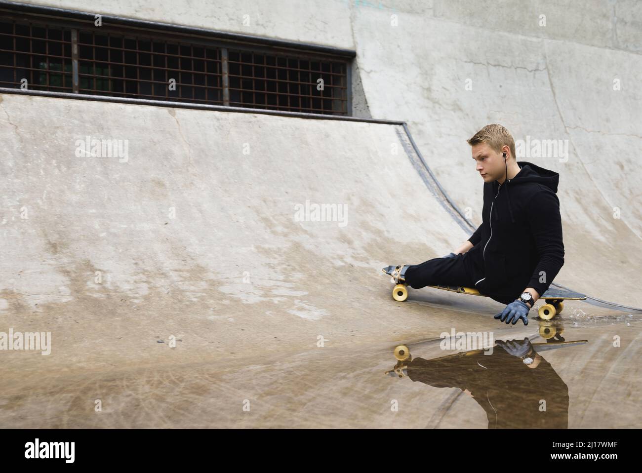 Motivated handicapped guy with a longboard in the skatepark Stock Photo ...