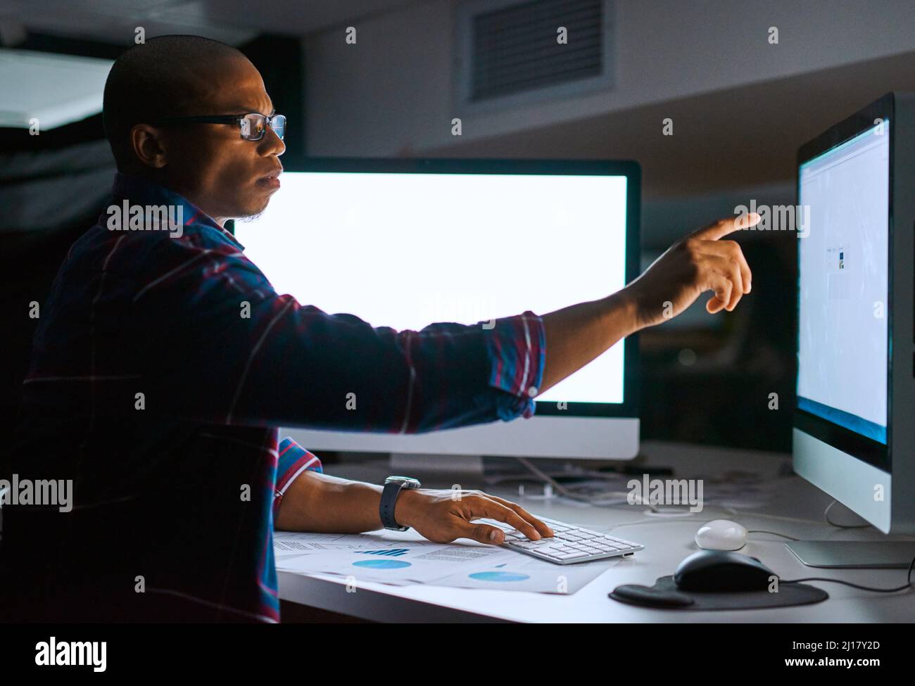 Reach out and touch the future. Cropped shot of a young male programmer working on computer code ...
