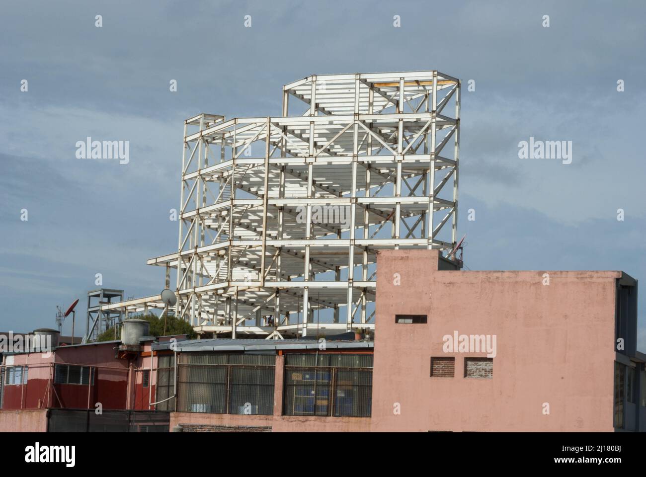 Construction of a steel-based building in Guatemala City at sunrise ...