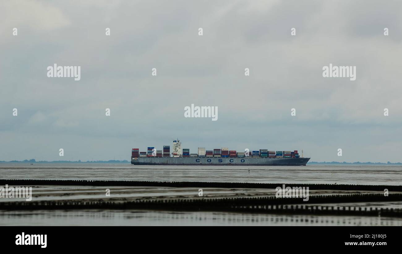 container ship is on the river Weser and am man in fron Stock Photo - Alamy