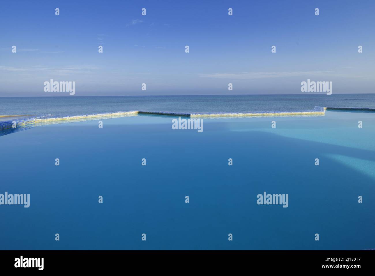view of the edge of an pool next to the sea during daytime Stock Photo ...