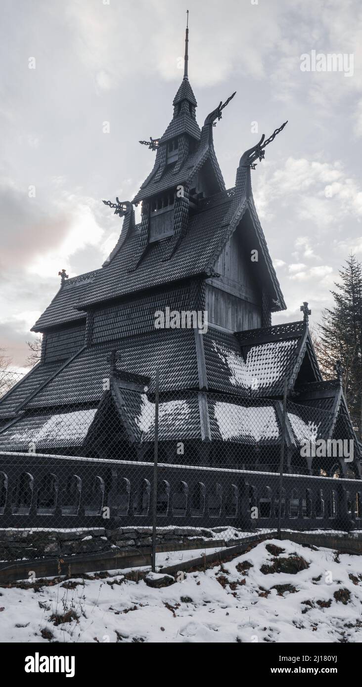 The facade of the Fantoft Stave Church in Bergen against a cloudy sky ...
