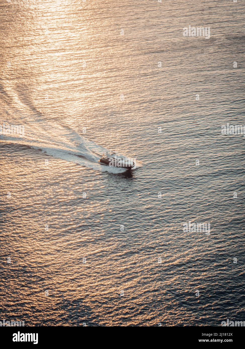 An aerial view of a boat in the sea during the sunset in Mallorca ...