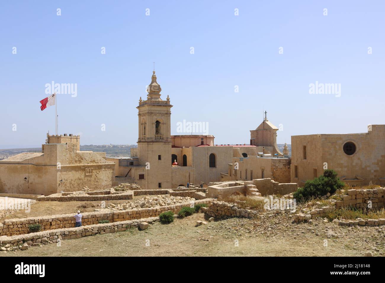 A castle on the hill in Malta with the waving flag Stock Photo - Alamy