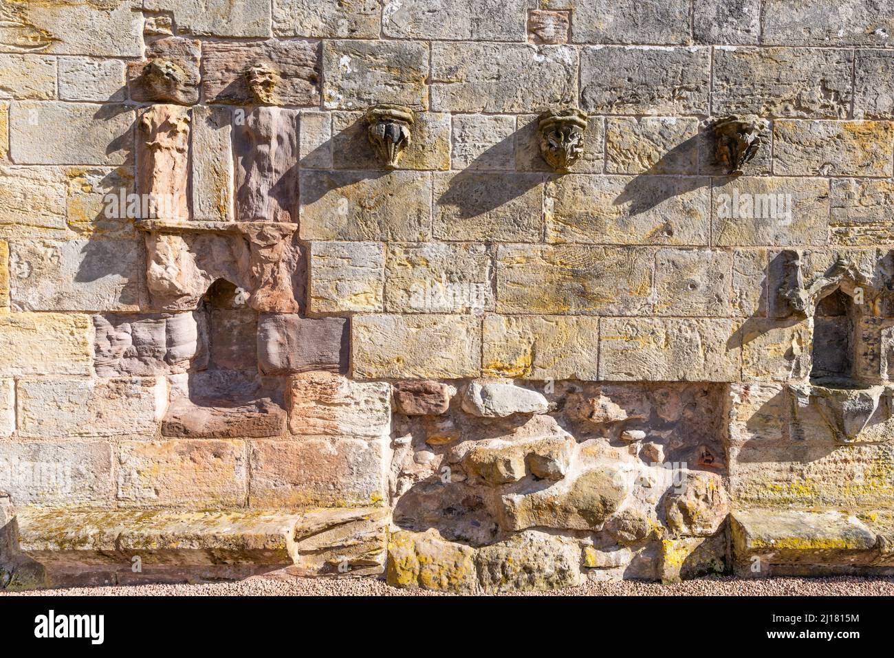 Interesting gothic chapel wall with rudimentary sculptures Stock Photo ...