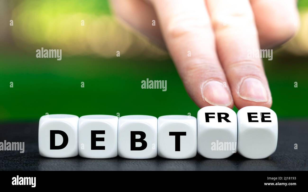 Hand turns dice and changes the expression "debt" to "debt free Stock ...