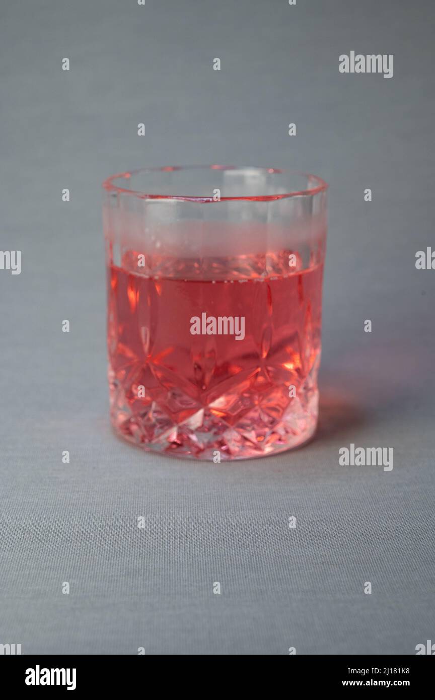 A glass of refreshing pink lemonade Fancy Fruity isolated on a gray ...