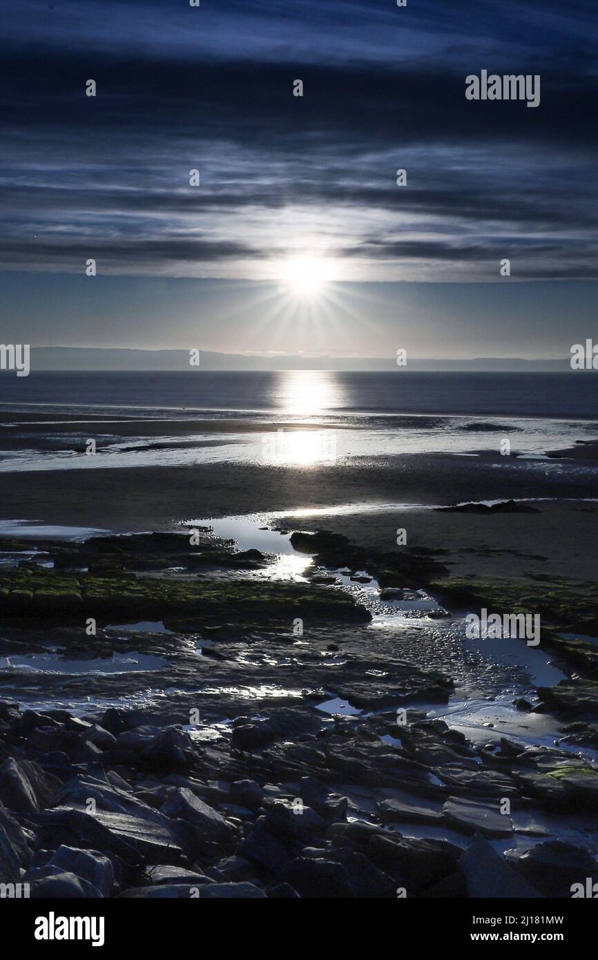 Moody coloured sunset on beach Stock Photo - Alamy