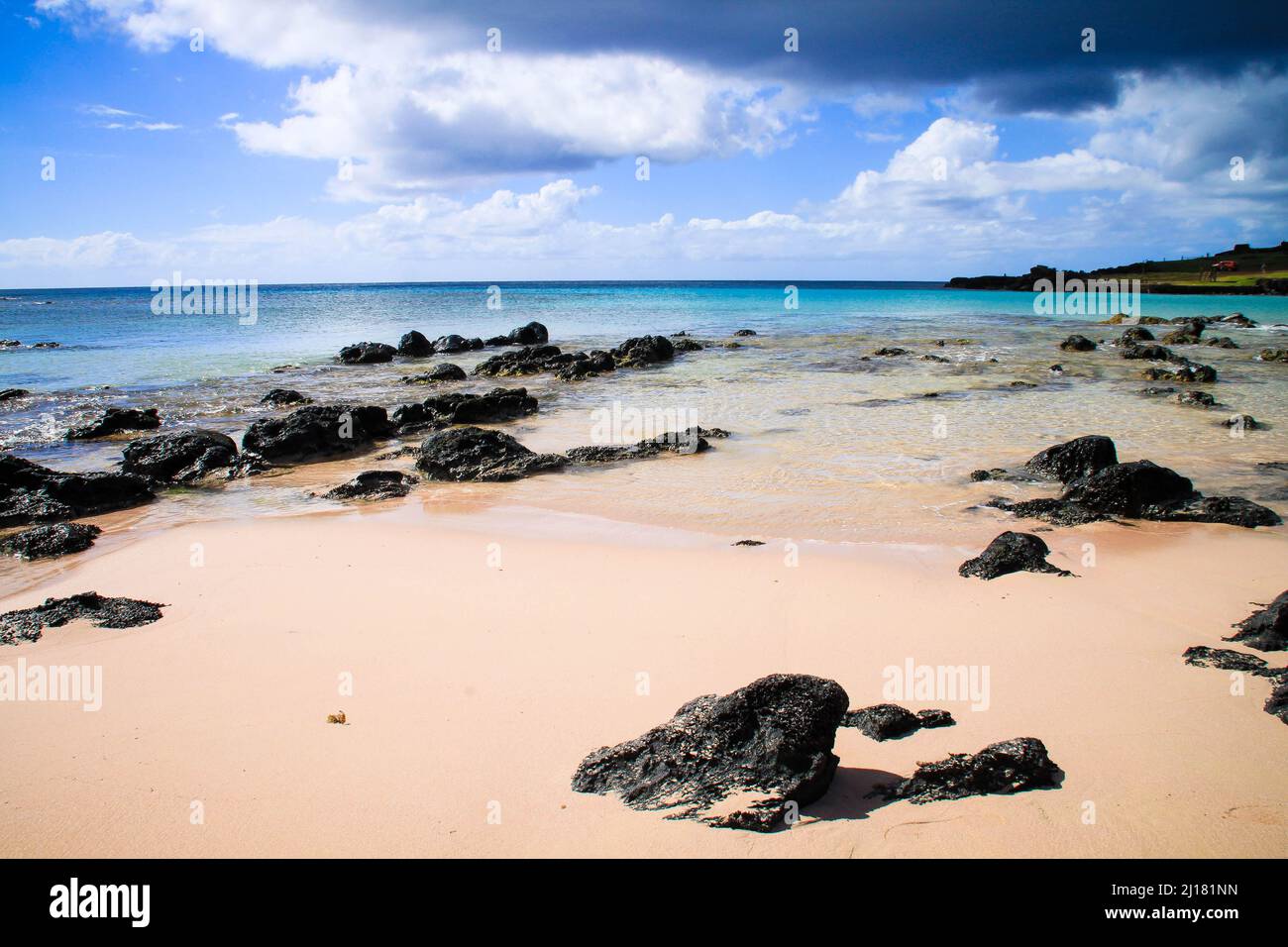 A beautiful view of rocky beach in Easter Island in background of ...
