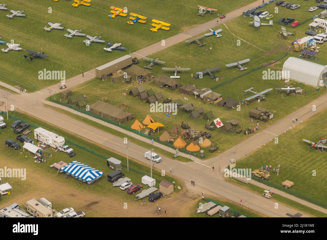 An aerial view of EAA Airventure grounds with planes and tents and the ...
