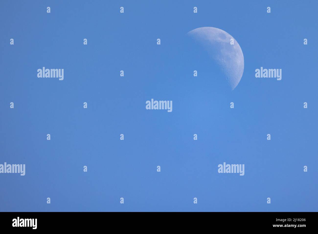 Half moon or waning moon with blue sky. The majestic moon, clear sky ...