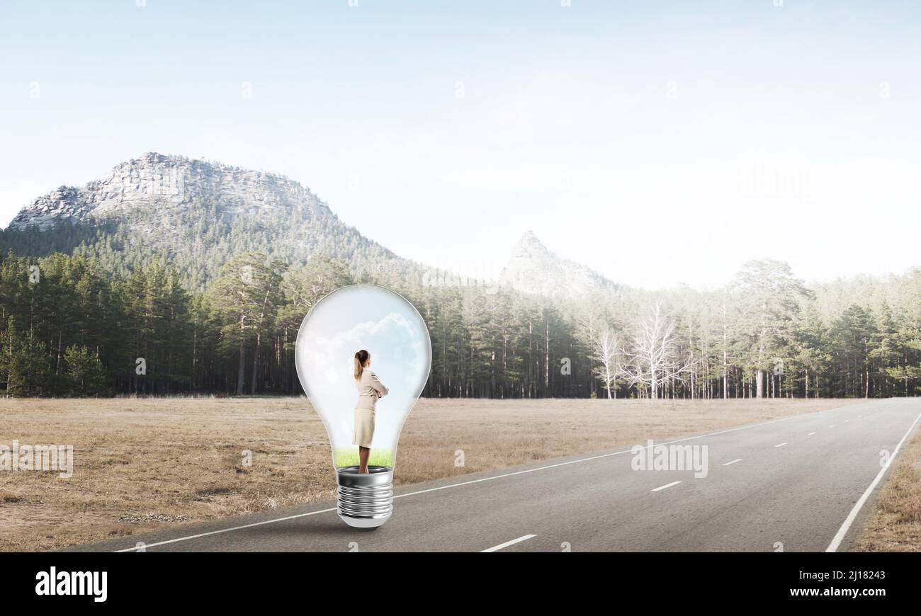 Businesswoman inside light bulb Stock Photo - Alamy