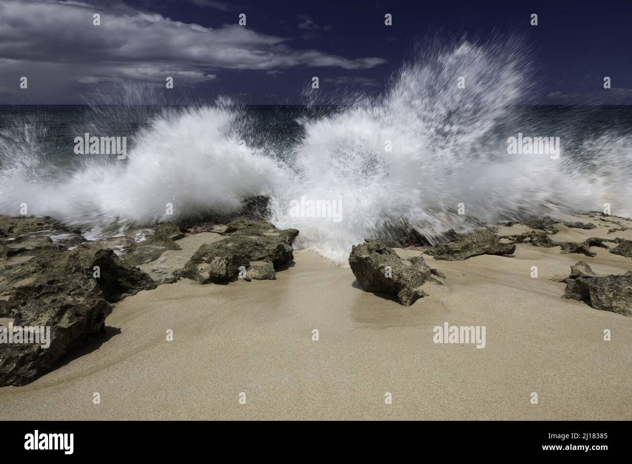 Freeze motion waves splashing against rocks at the shoreline of Hawaii ...