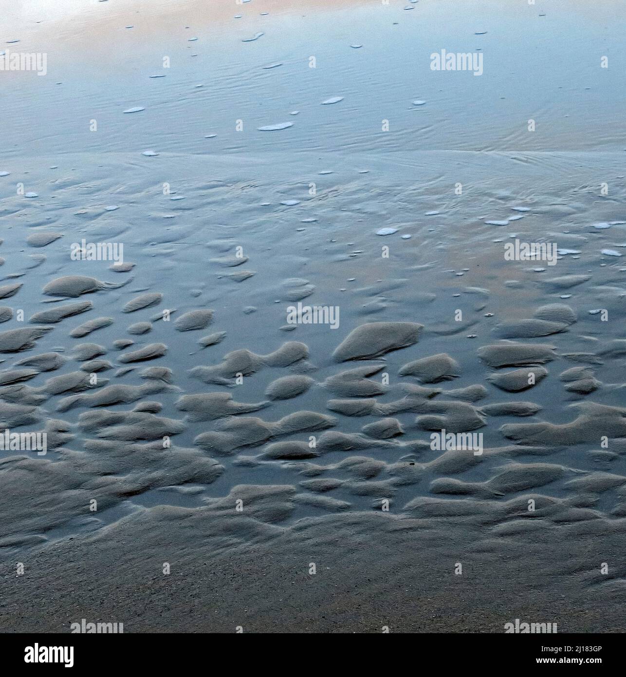 Abstract detailed tidal patterns in the sand at low tide on Penbryn ...