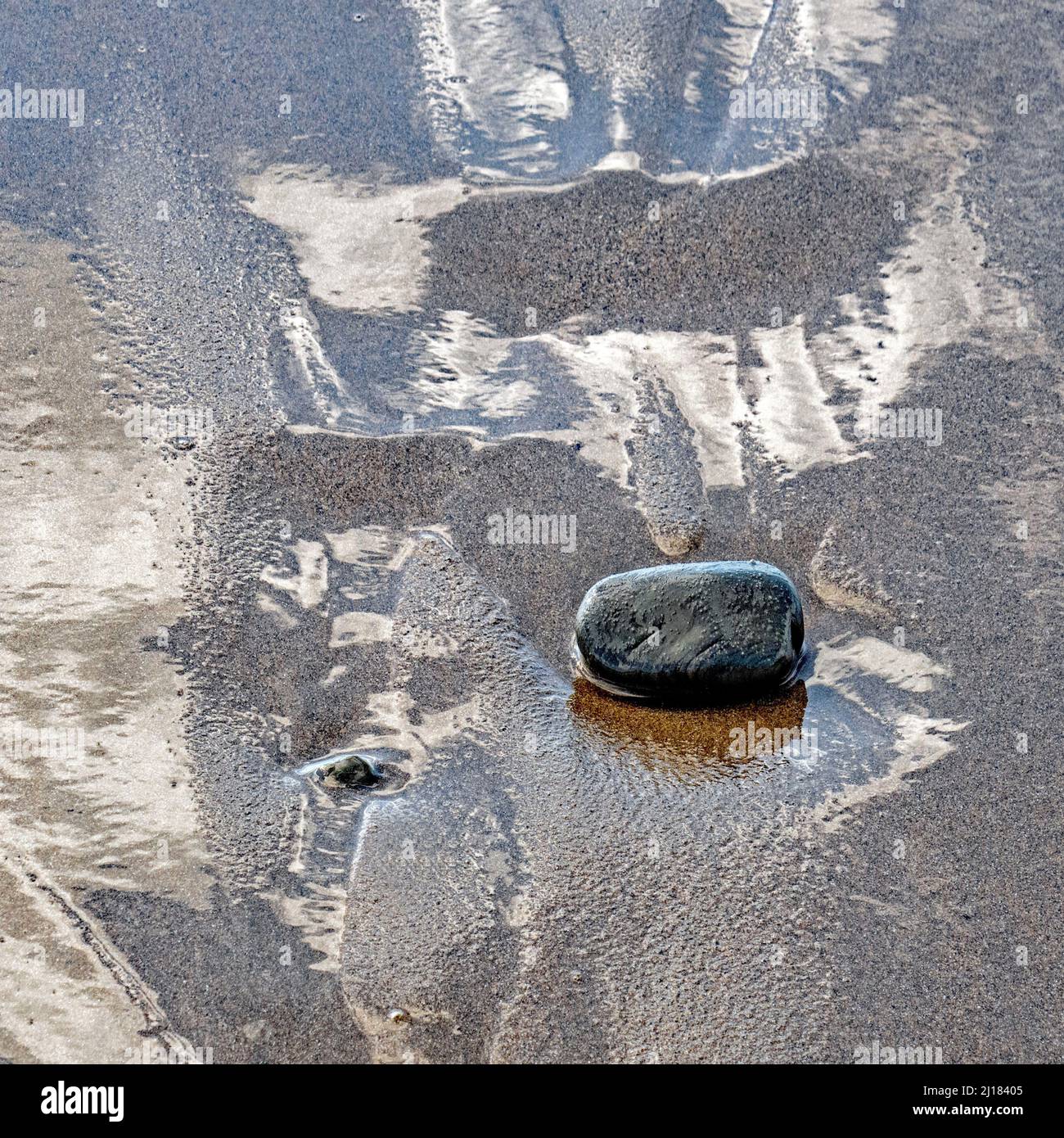Colour photograph of coastal stones on beach smoothed and rounded by ...
