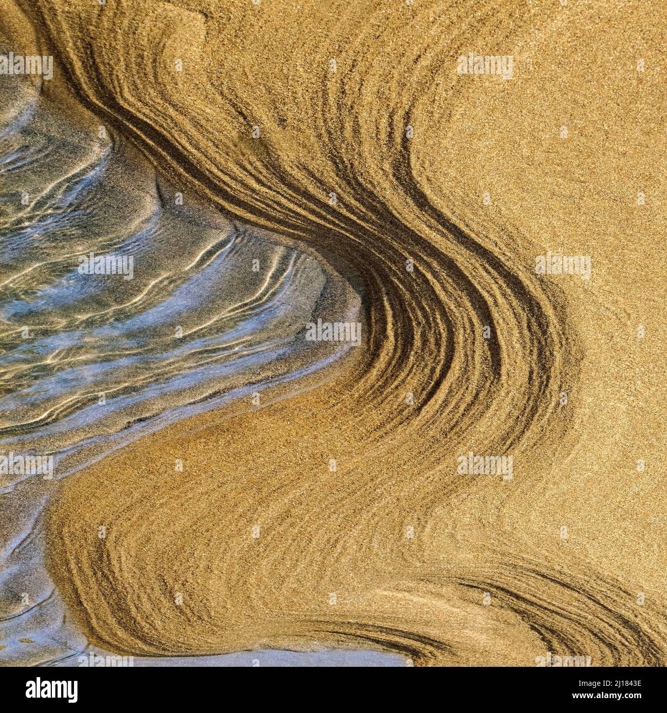 Abstract detailed tidal patterns in the sand at low tide on Penbryn ...