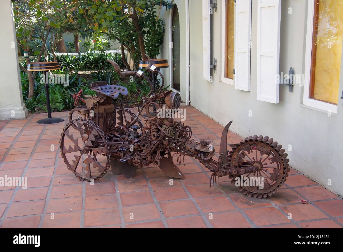 A vintage rusty tricycle on display in a courtyard Stock Photo - Alamy