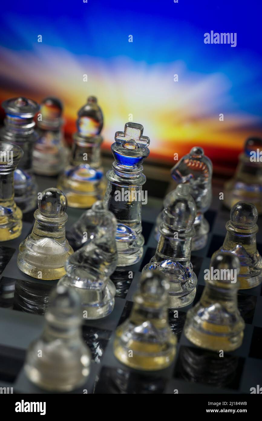 Glass chess and color sunset backdrop Stock Photo - Alamy