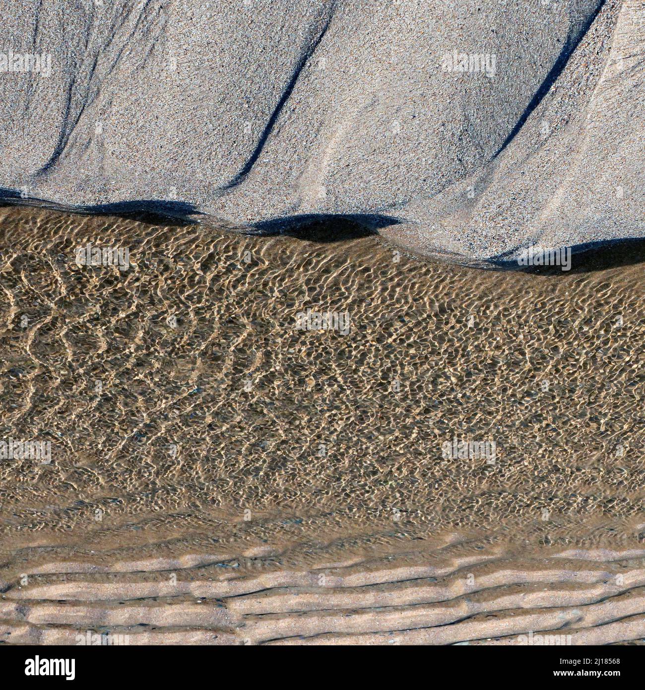 Abstract detailed tidal patterns in the sand at low tide on Penbryn ...