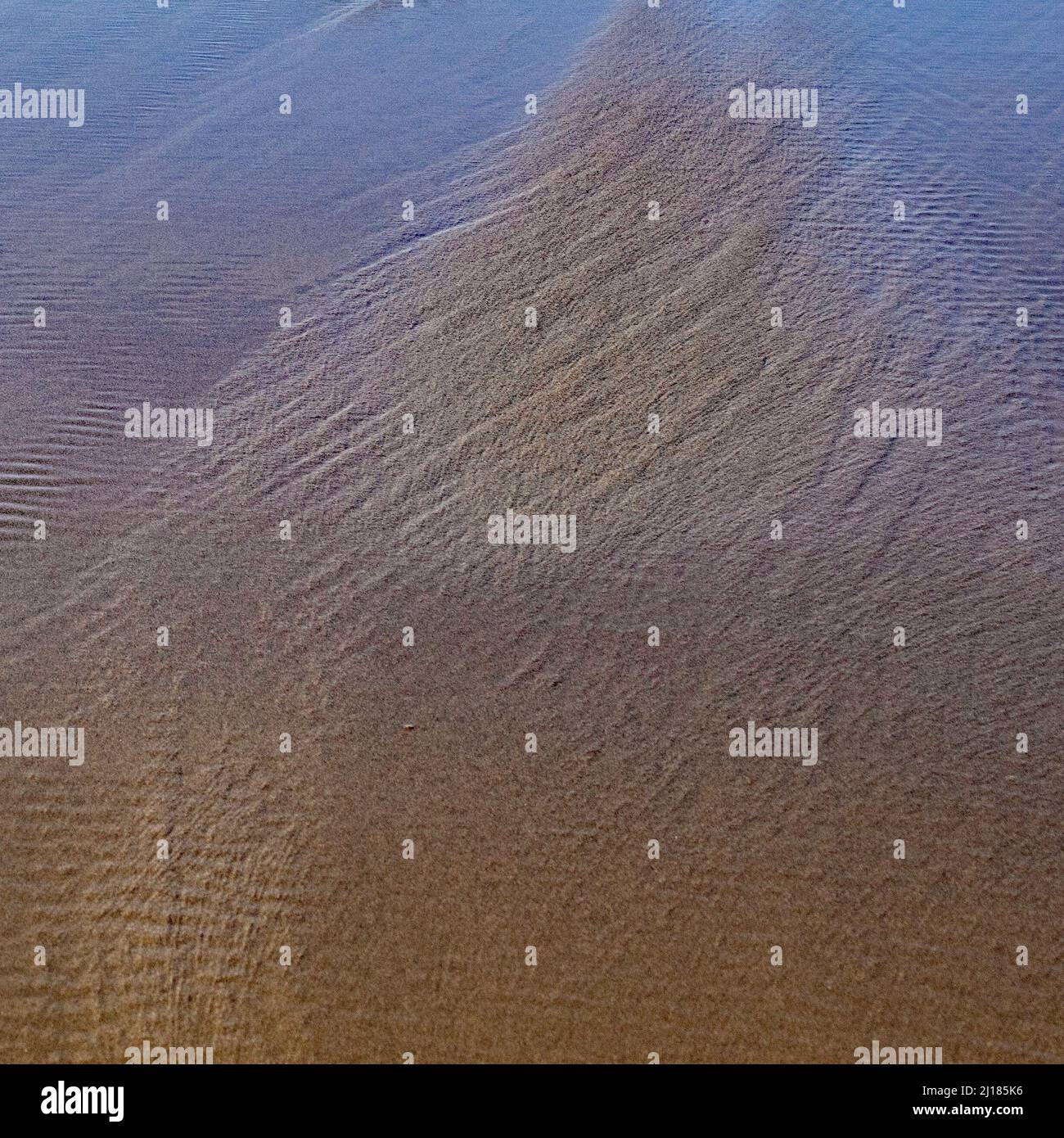 Abstract detailed tidal patterns in the sand at low tide on Penbryn ...