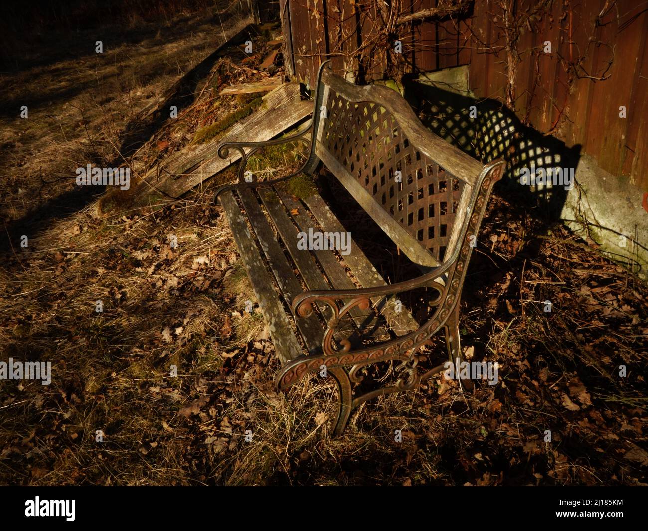 An old vintage wrought iron garden bench with decorative details in the ...