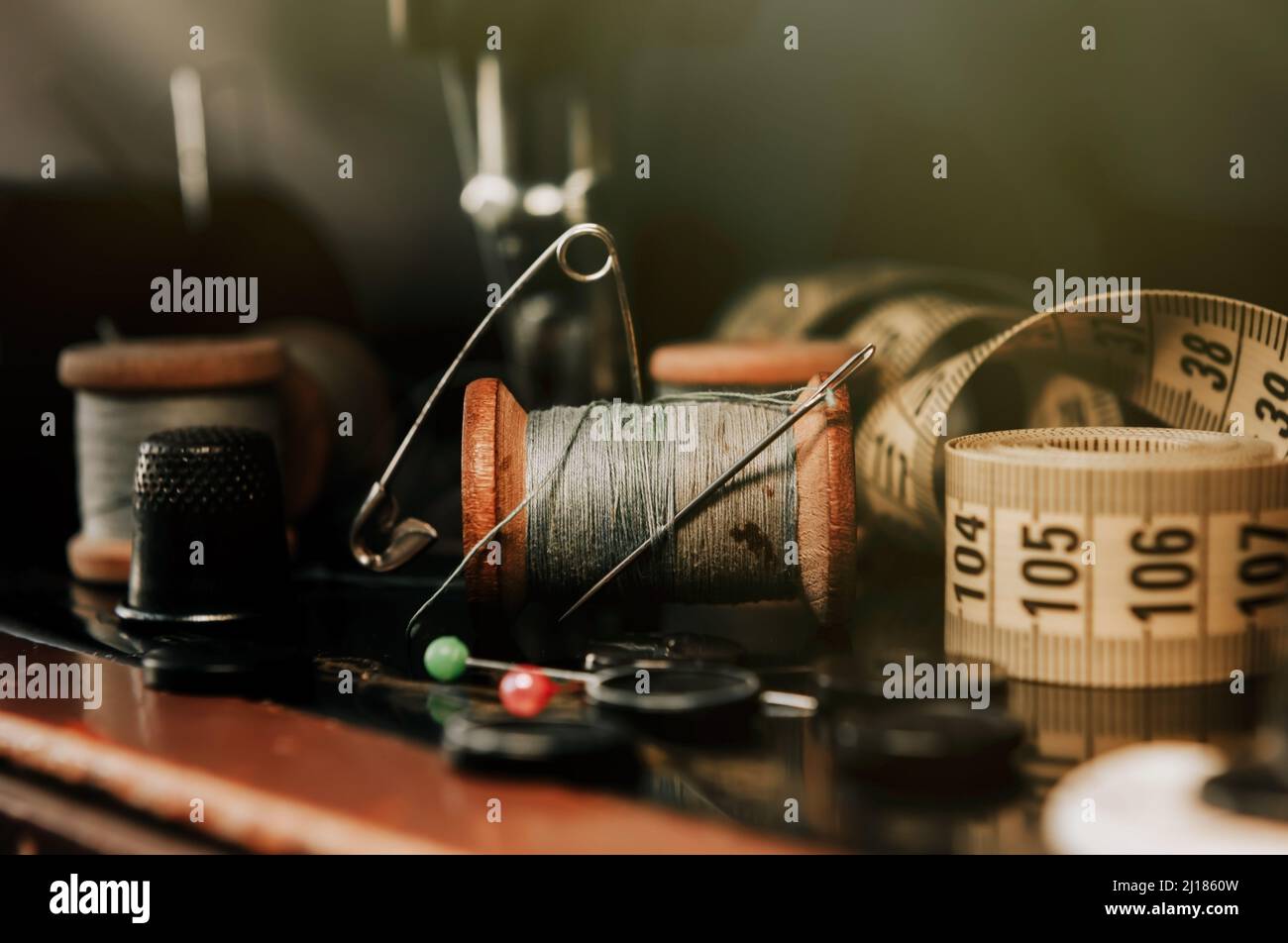 Old retro tailor's tools for sewing clothes. Centimeter, scissors ...