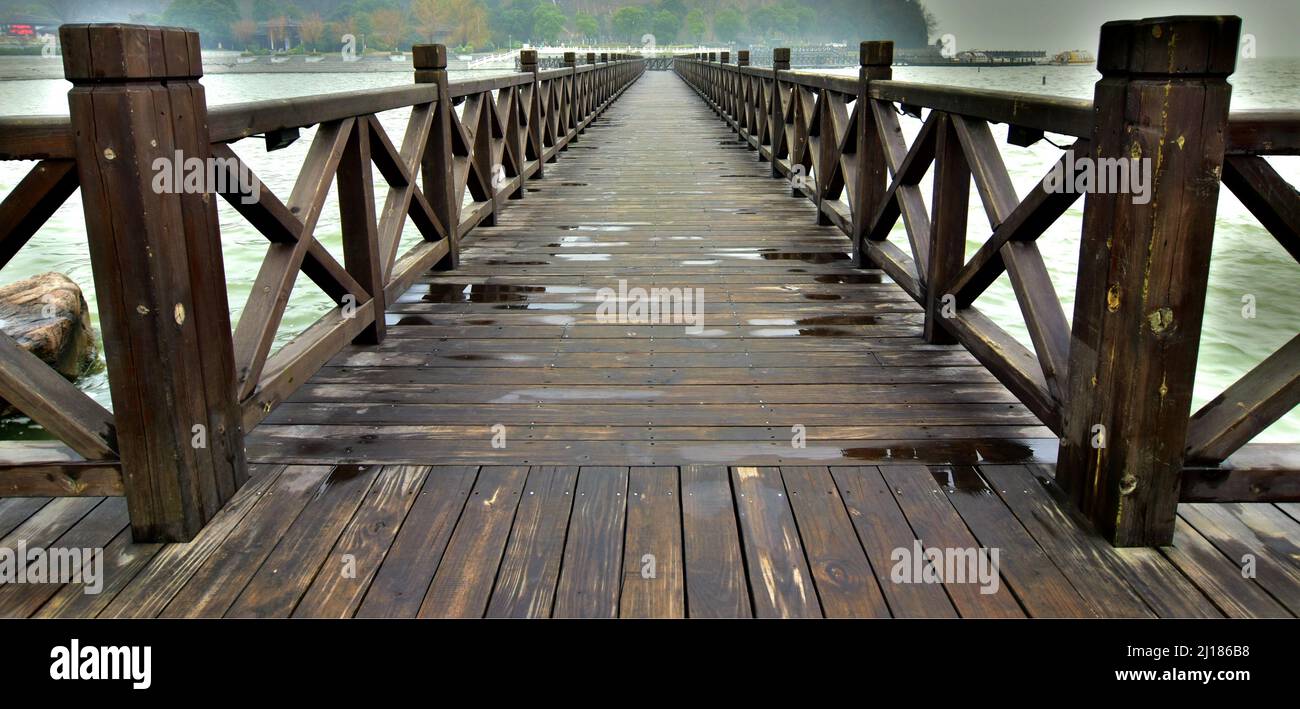 A wet pier or bridge over a river Stock Photo - Alamy