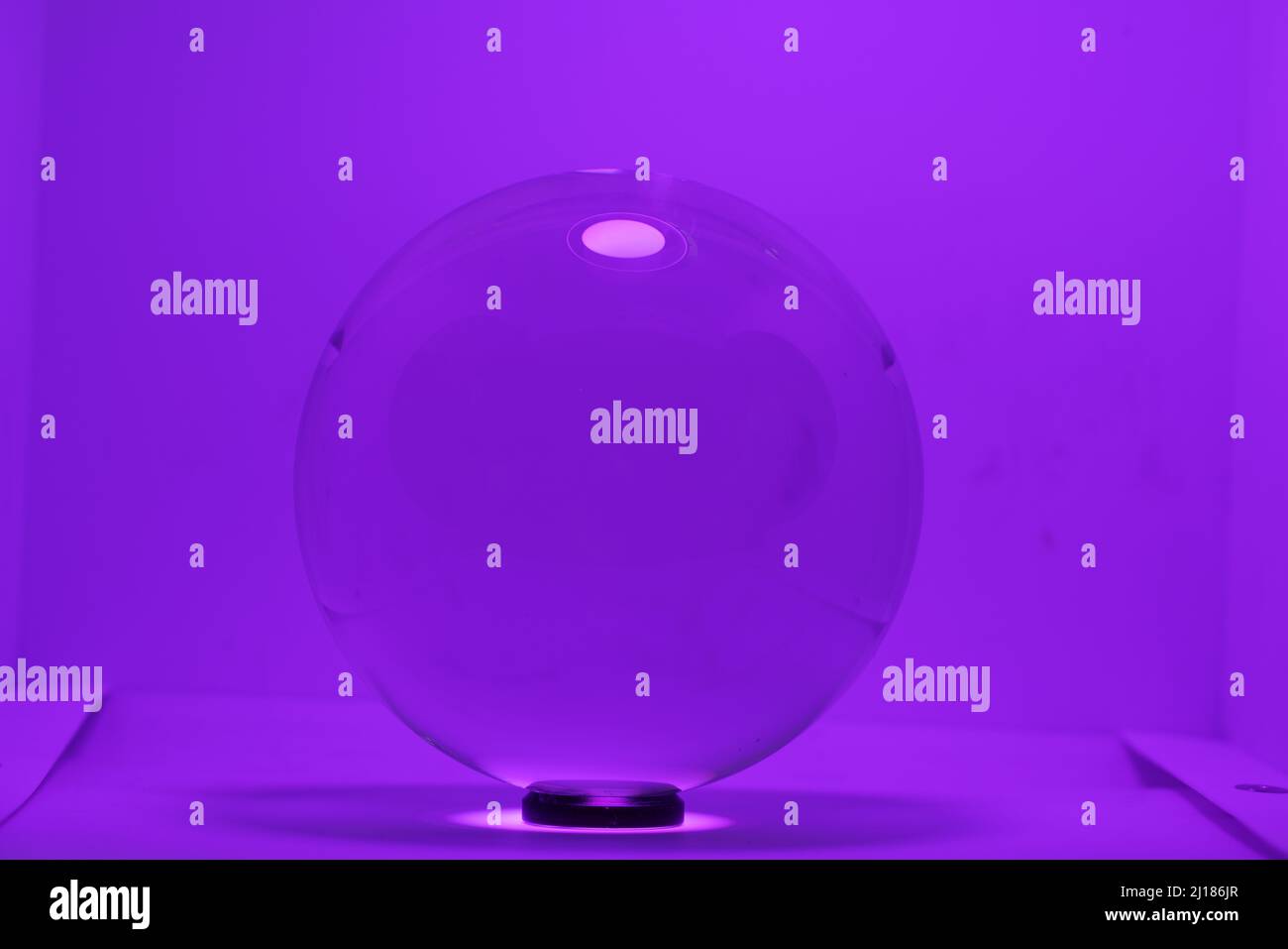 A purple crystal ball on a purple background Stock Photo - Alamy