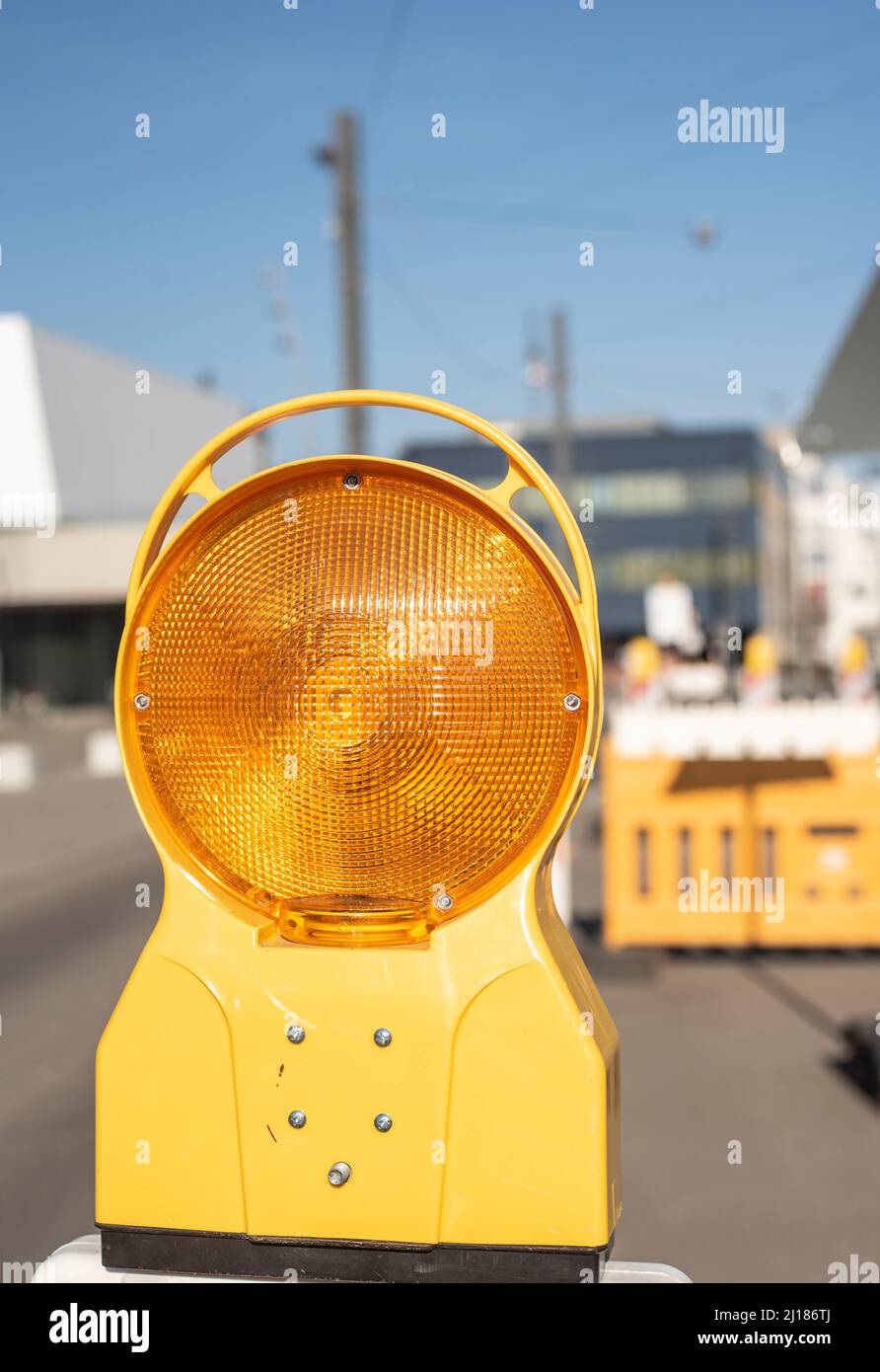 the yellow colored reflector of a warning sign at a road construction ...