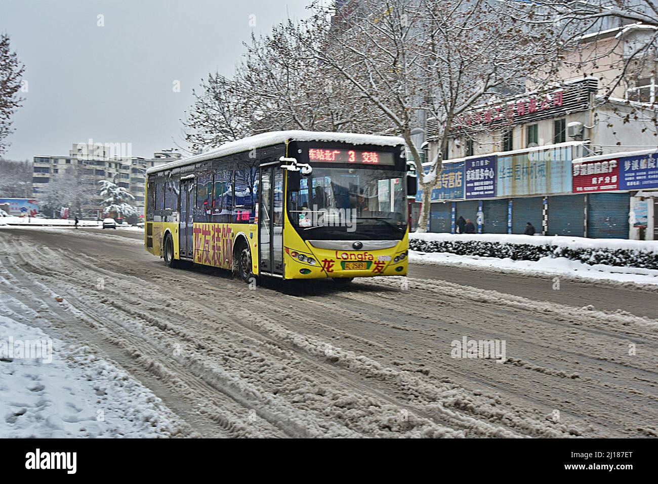 a photo of early morning bus on snow route Stock Photo - Alamy