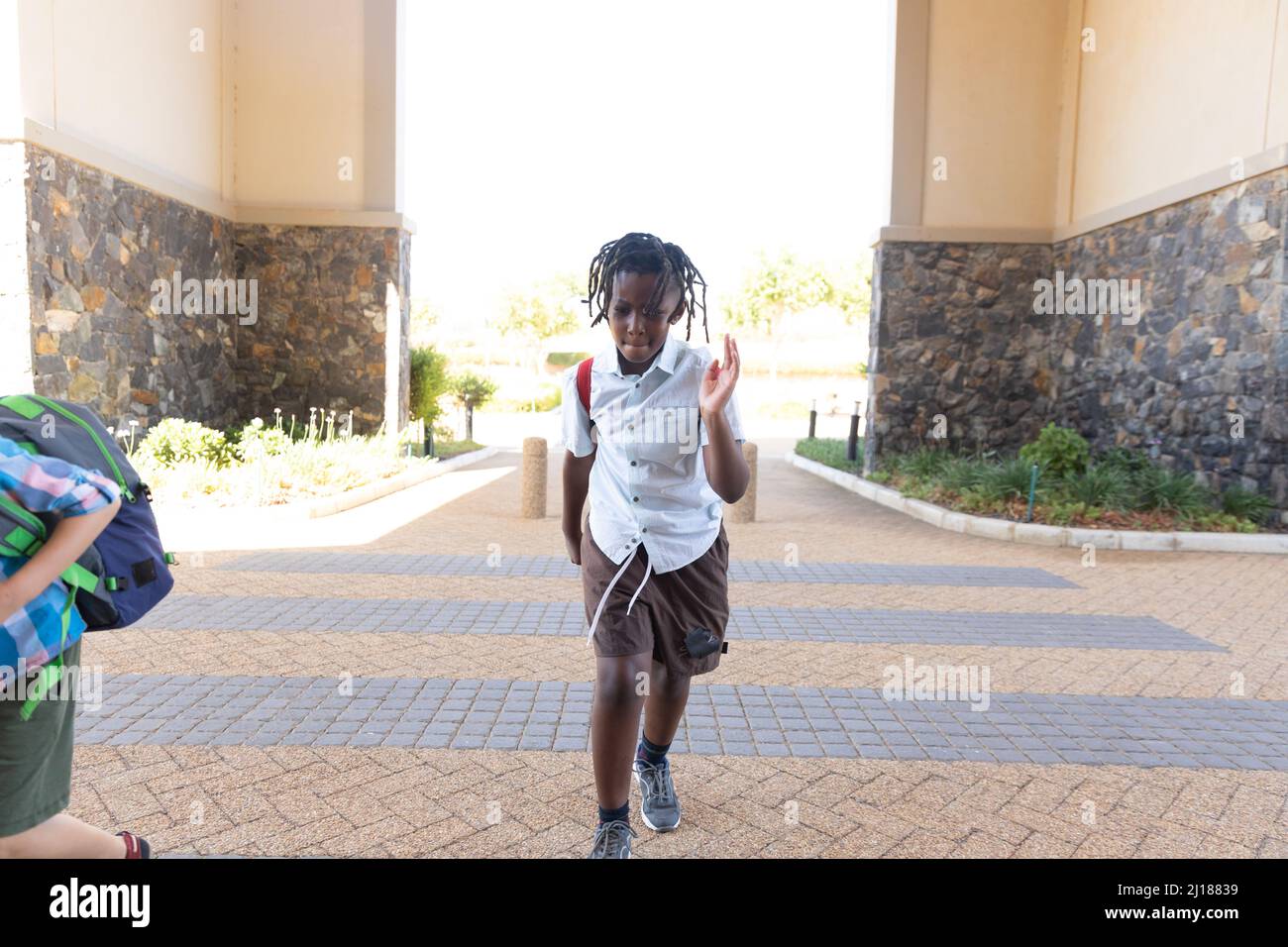 African american elementary schoolboy running for school Stock Photo ...