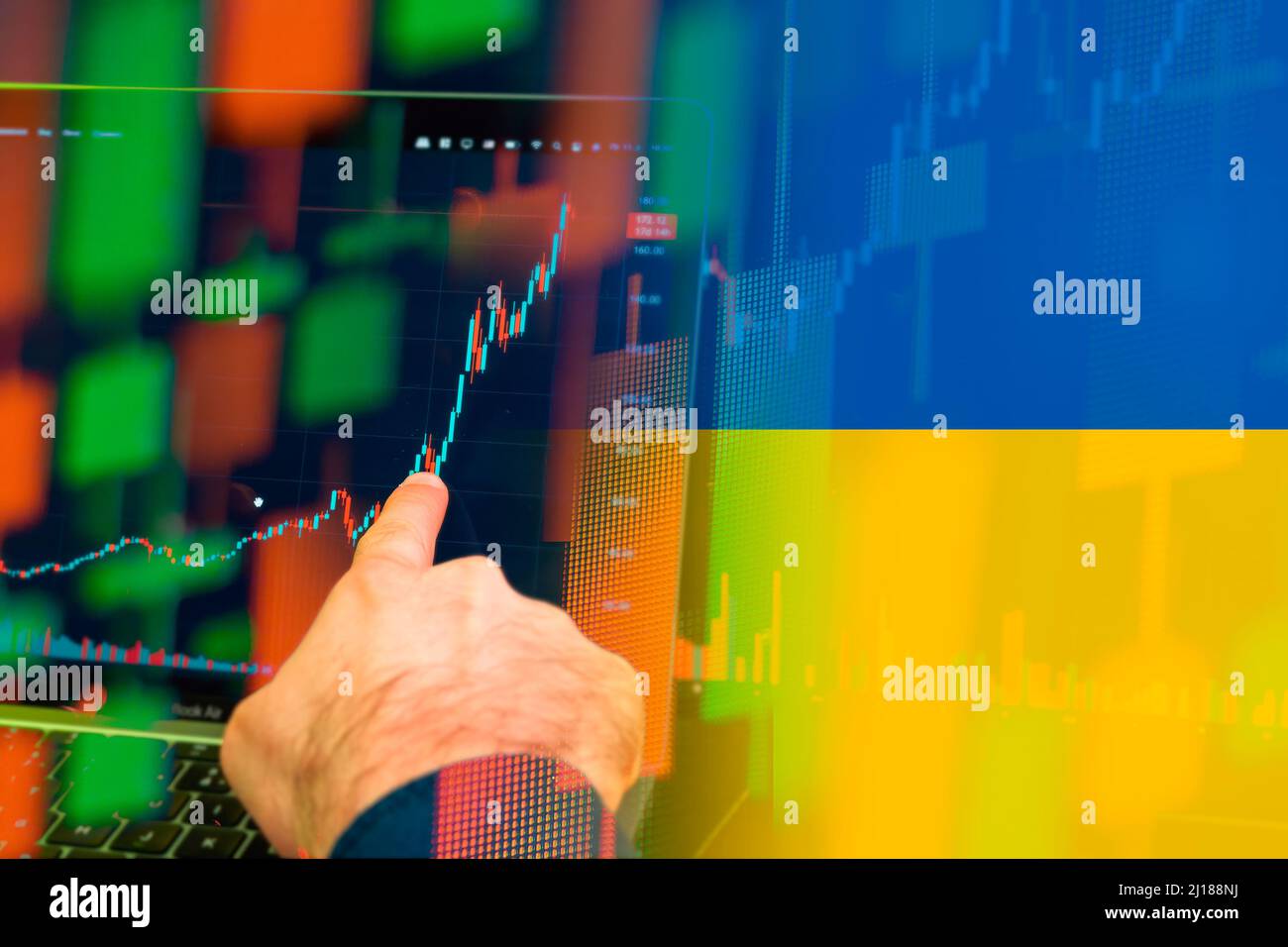 Ukraine uptrend of the economy. Man hand shows on the increasing candle ...