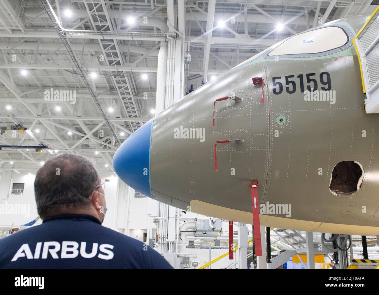 An employee looks at an Airbus A220 plane at the Airbus Canada LP ...