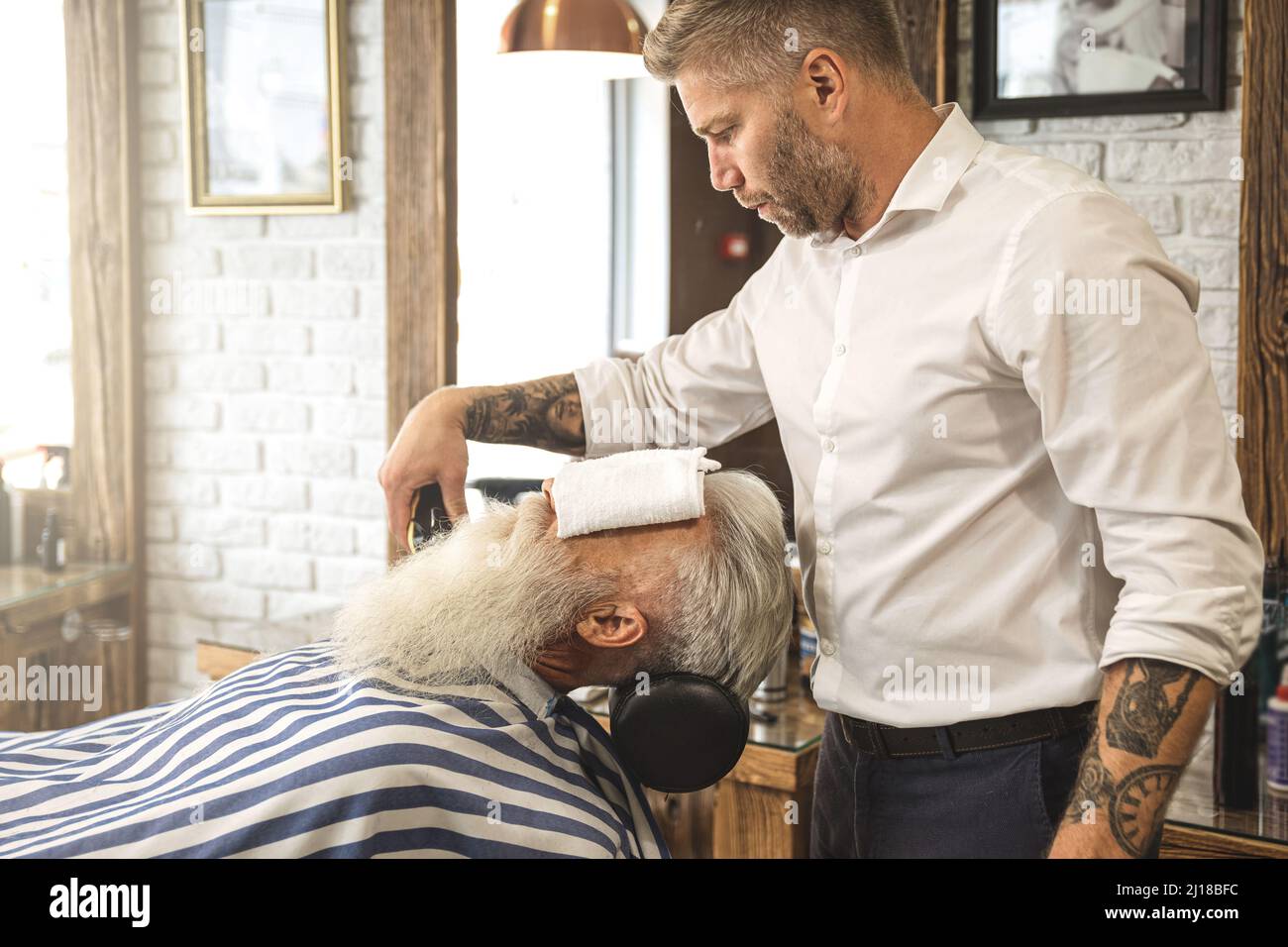 Handsome senior man getting styling and trimming of his beard Stock ...