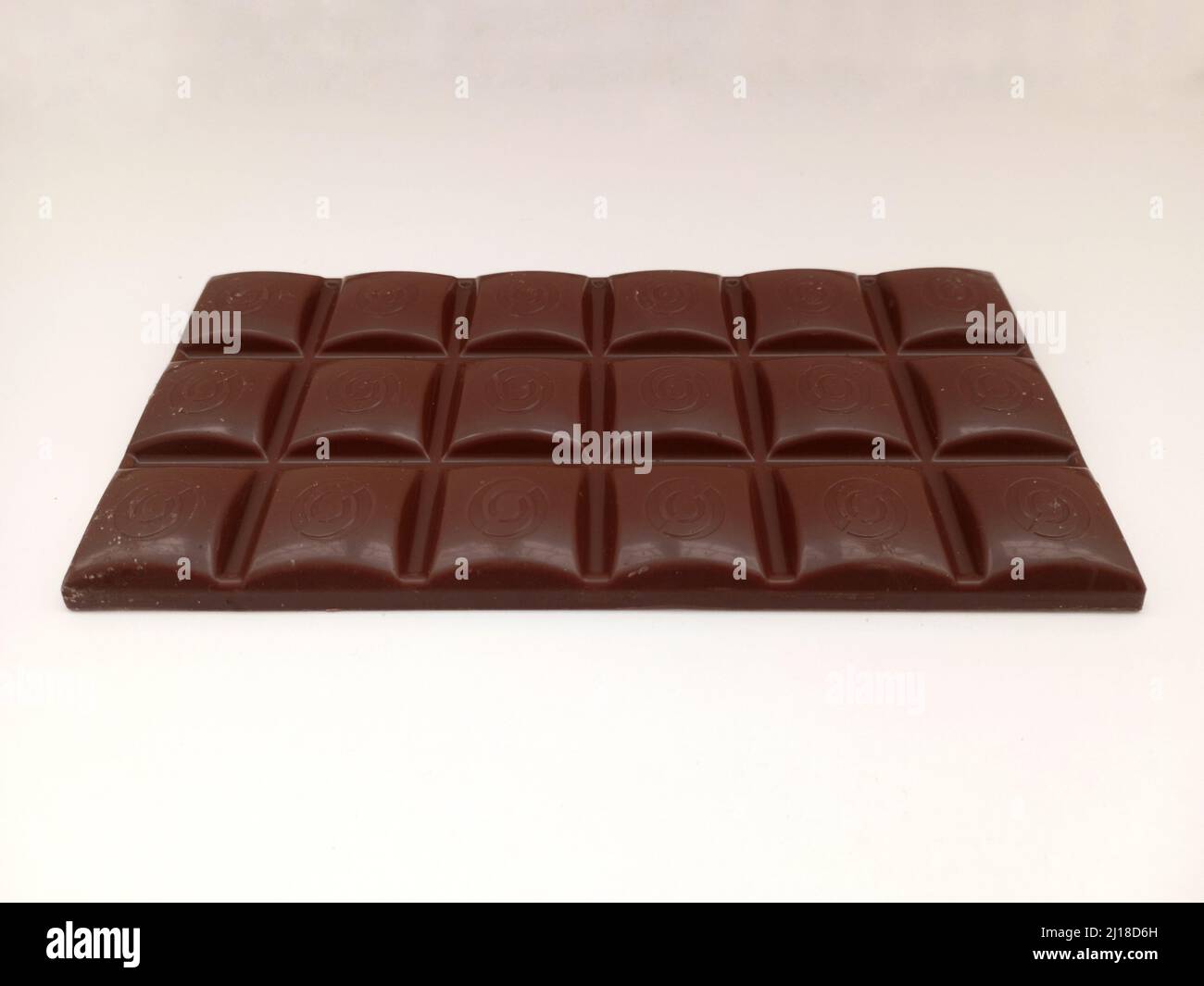 Dark chocolate bar texture isolated on white background from back view ...