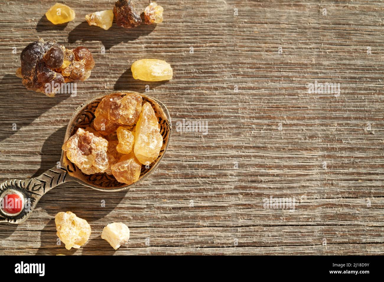 Frankincense resin crystals on a wooden background with copy space ...