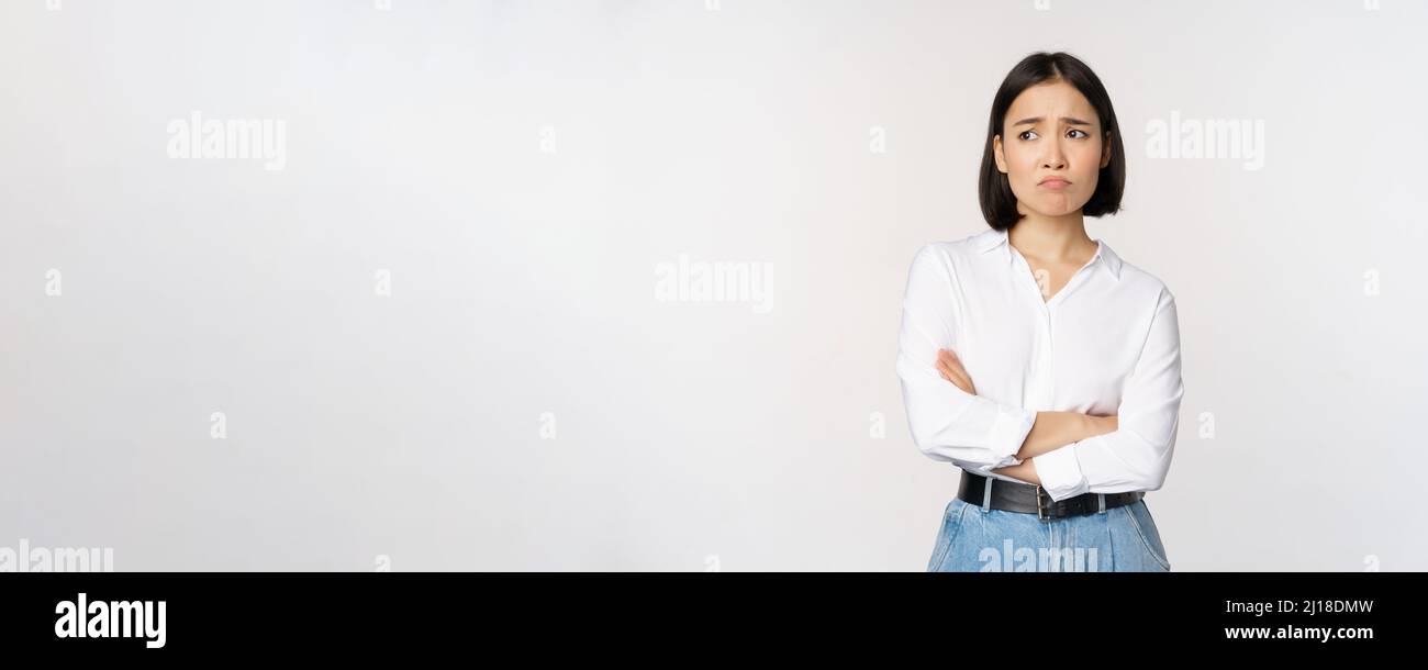 Image of sad office girl, asian woman sulking and frowning disappointed ...