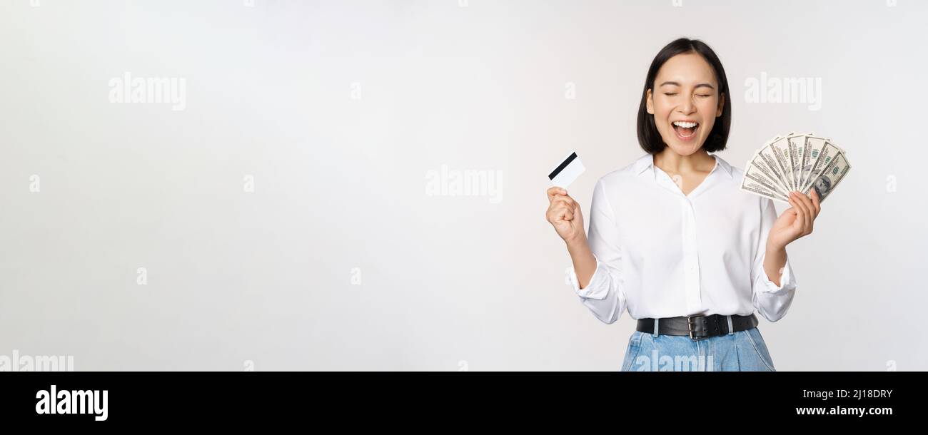 Finance and money concept. Happy young asian woman dancing with cash ...