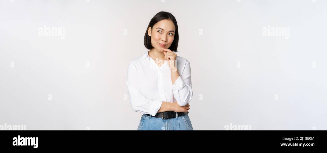 Image of thoughtful smiling woman has an idea, scheming, planning ...
