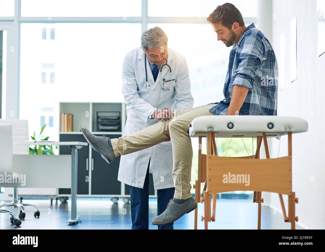 Did you feel that. Shot of a confident mature male doctor running tests ...