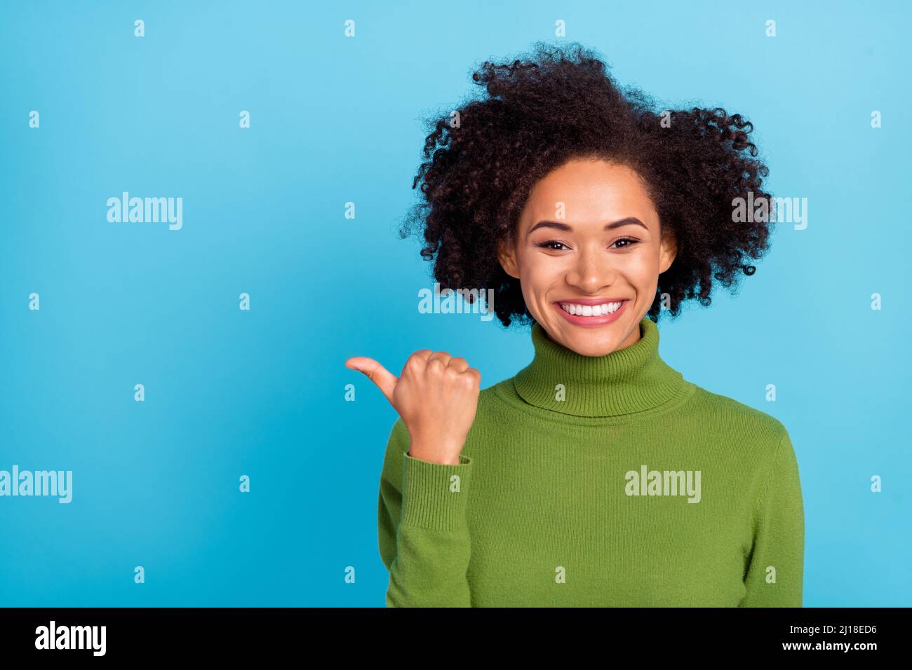 Photo of pretty cheerful lady indicate thumb empty space offer promo ...